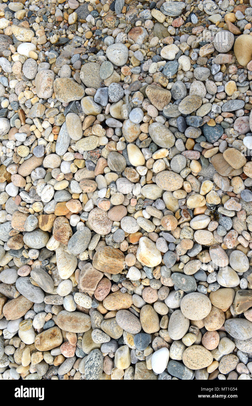 Closeup of rocks, pebbles and boulders on rocky beach which have been ...