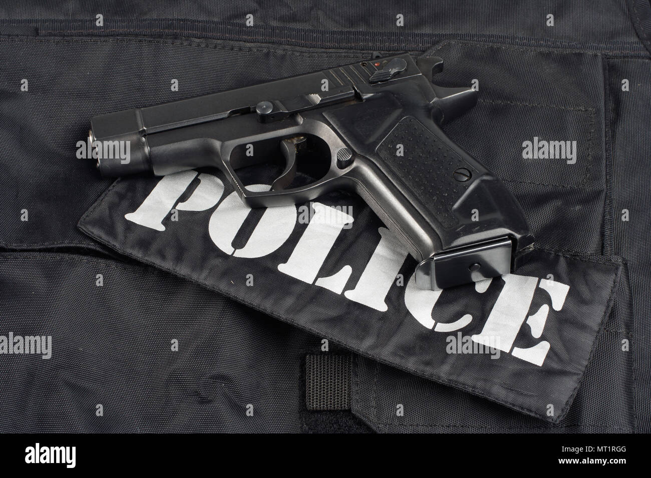 police handgun on black uniform background Stock Photo - Alamy