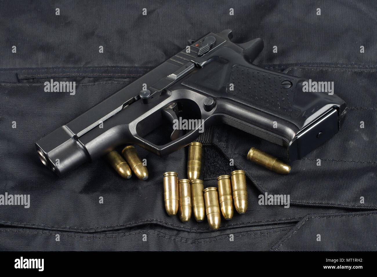 police handgun on black uniform background Stock Photo - Alamy