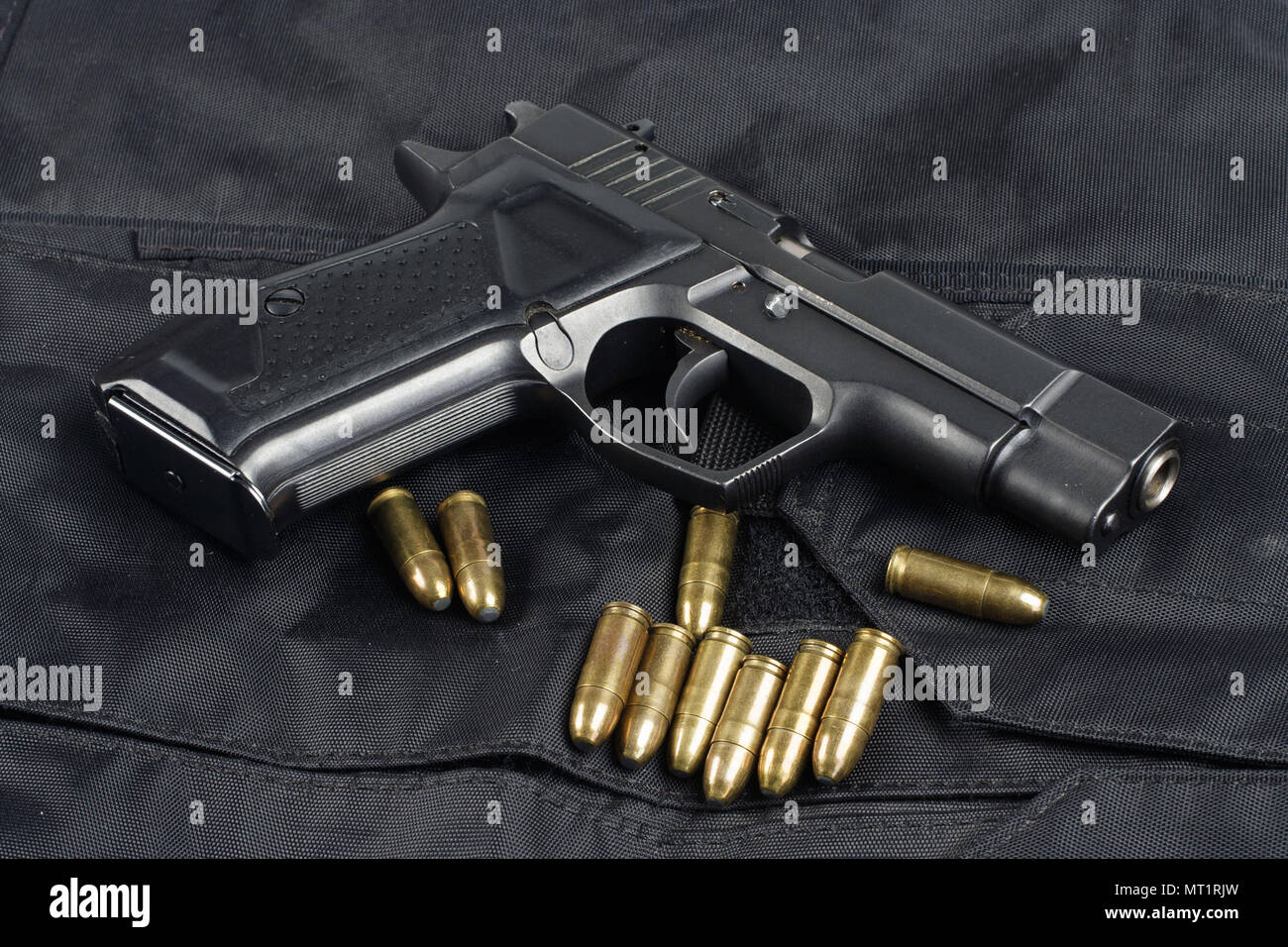police handgun on black uniform background Stock Photo - Alamy