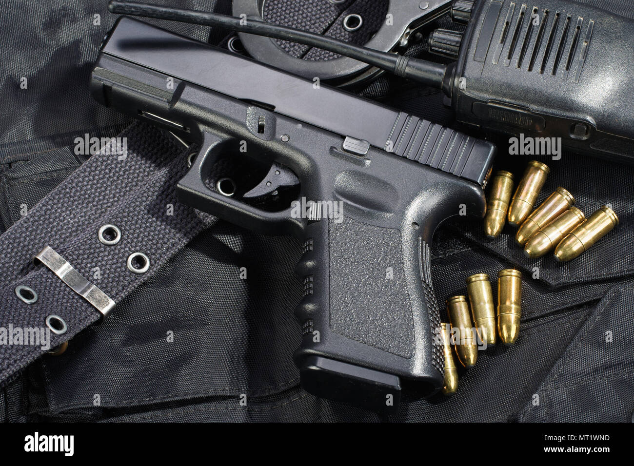 Police weapon and equipment on black uniform background Stock Photo - Alamy