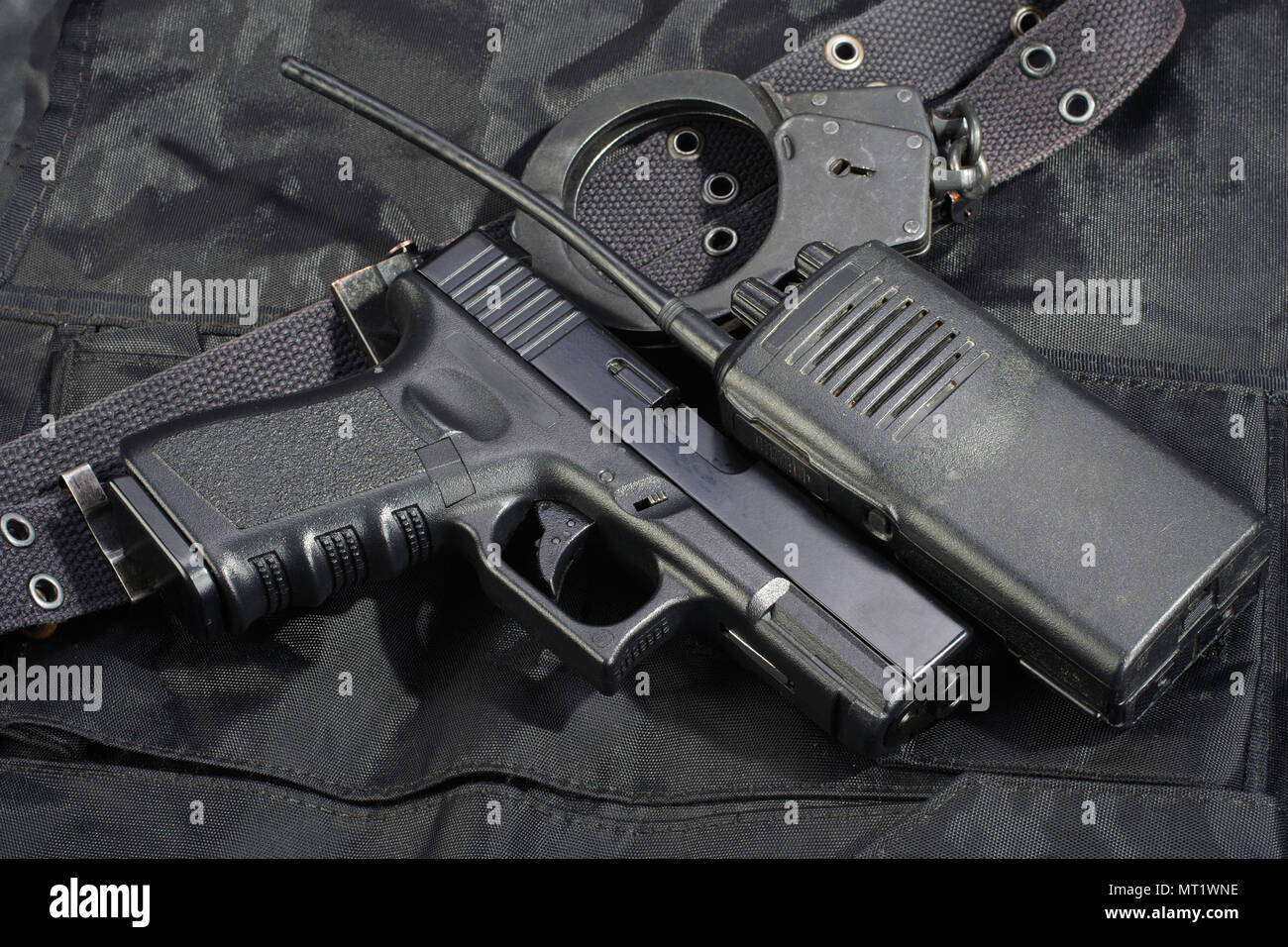 Police weapon and equipment on black uniform background Stock Photo - Alamy