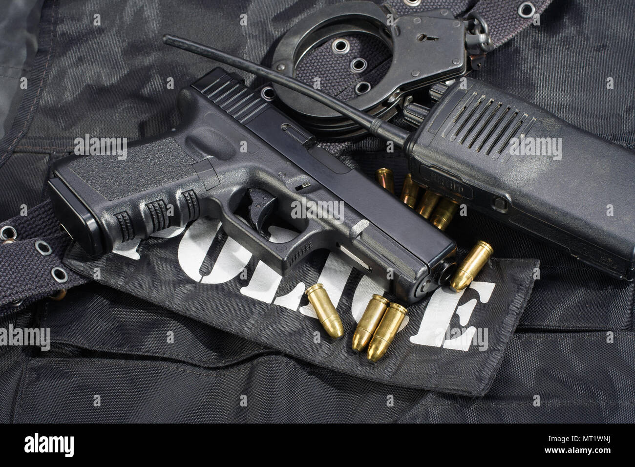 Police weapon and equipment on black uniform background Stock Photo - Alamy