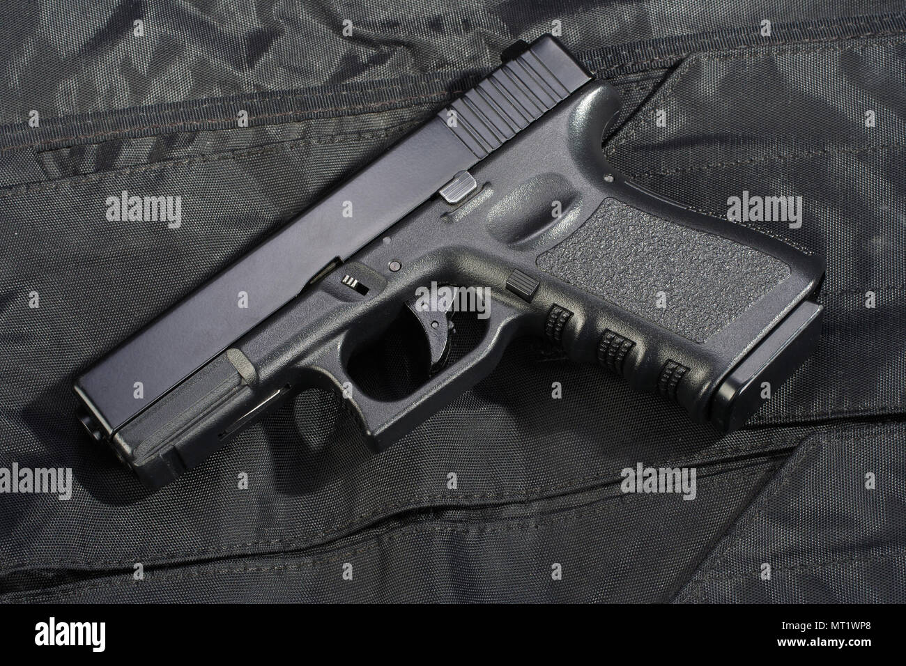 Police weapon and equipment on black uniform background Stock Photo - Alamy