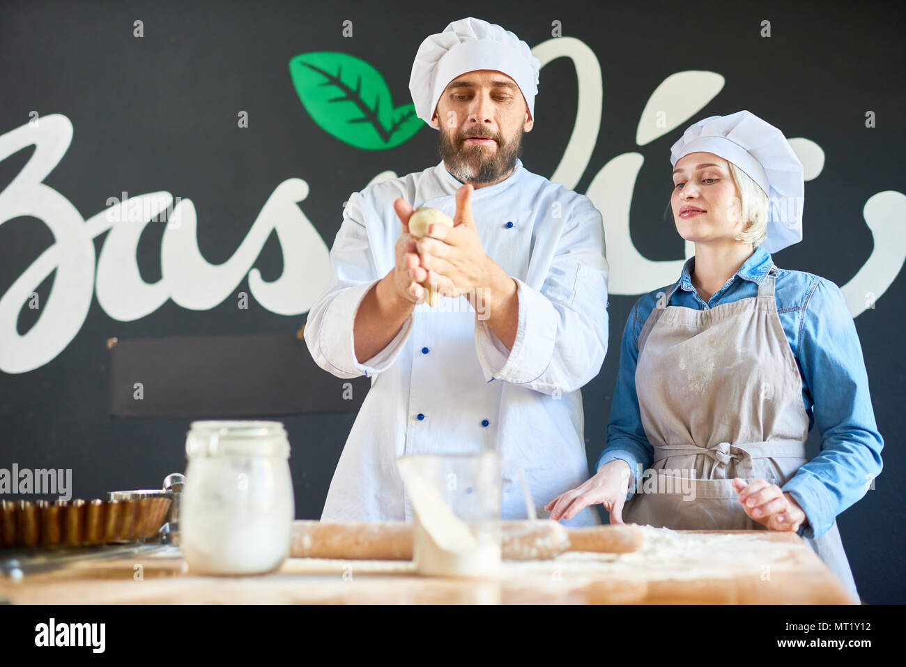 Cook and chef working with dough Stock Photo - Alamy