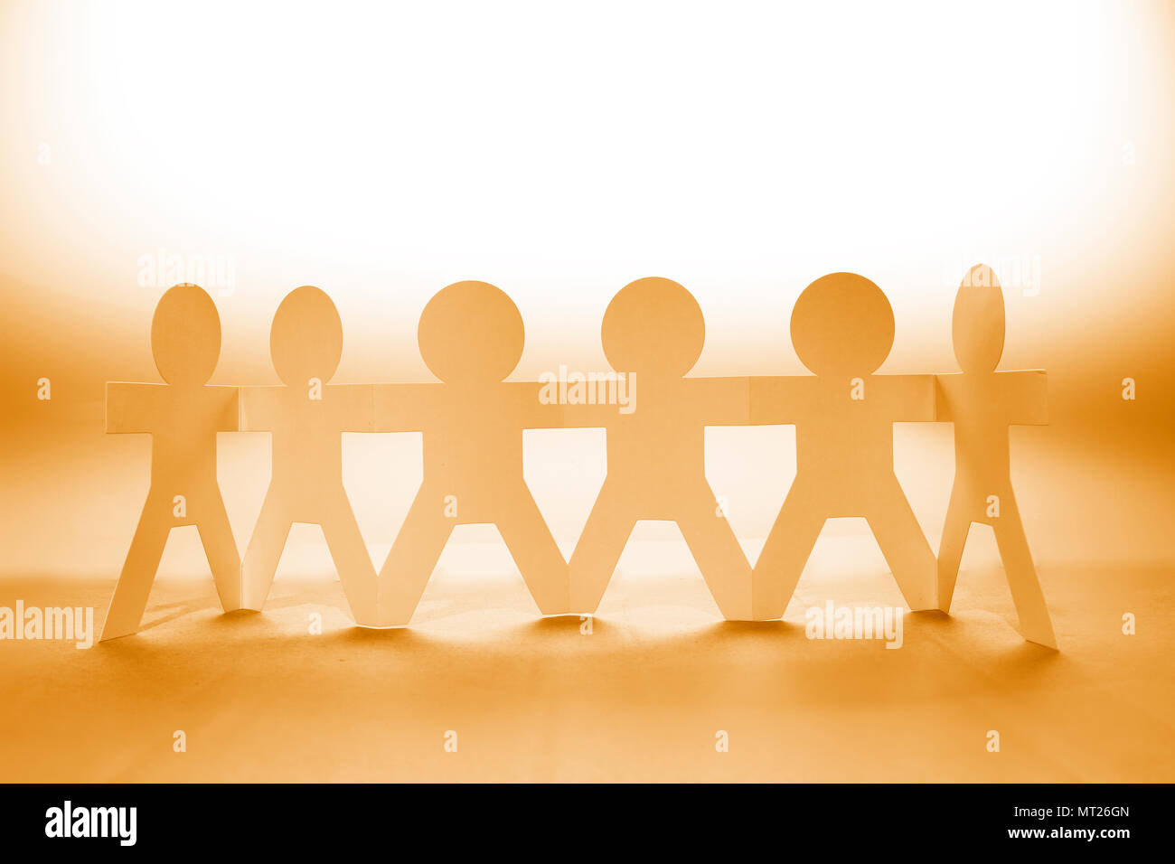 Team of paper chain people in a row holding hands Stock Photo - Alamy