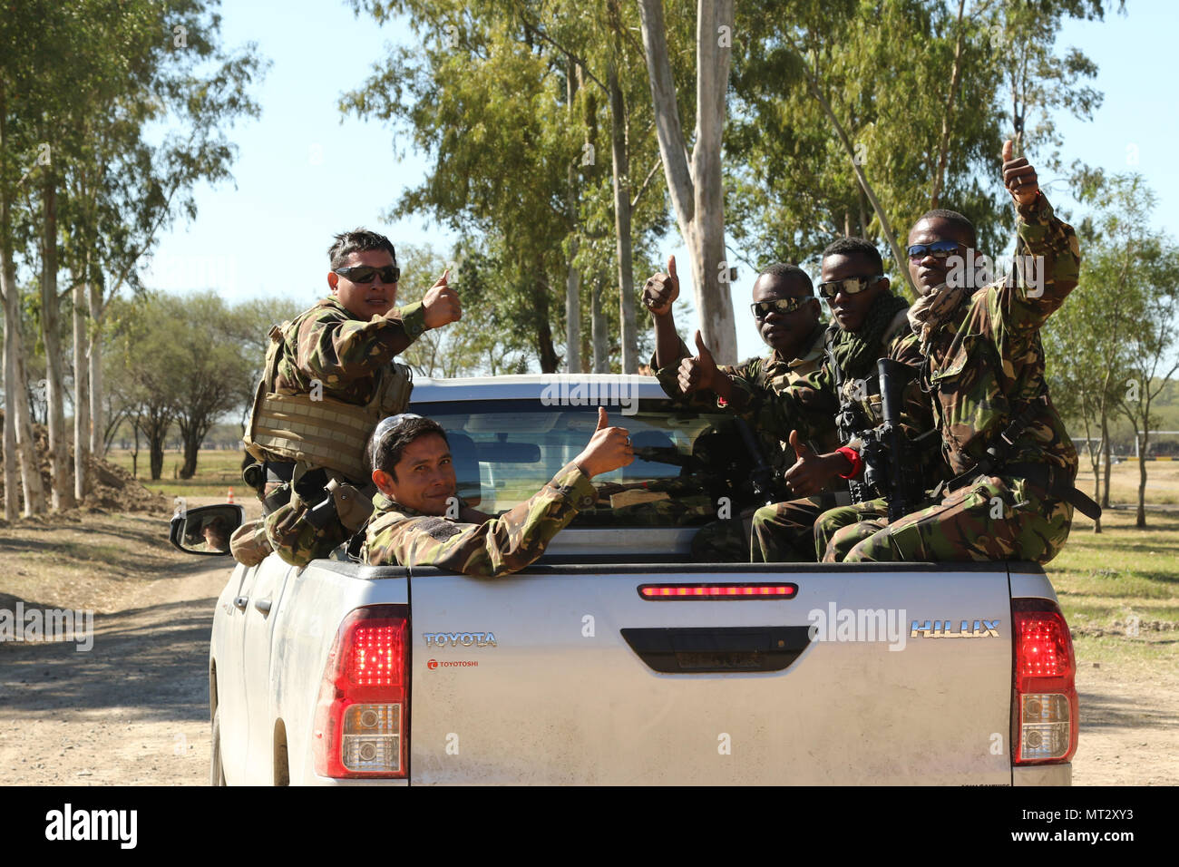 Team Belize catches a ride from the range after competing in a timed ...