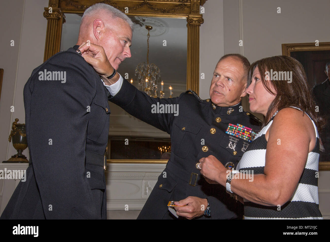 Commandant of the Marine Corps Gen. Robert B. Neller, center, pins a Lt ...