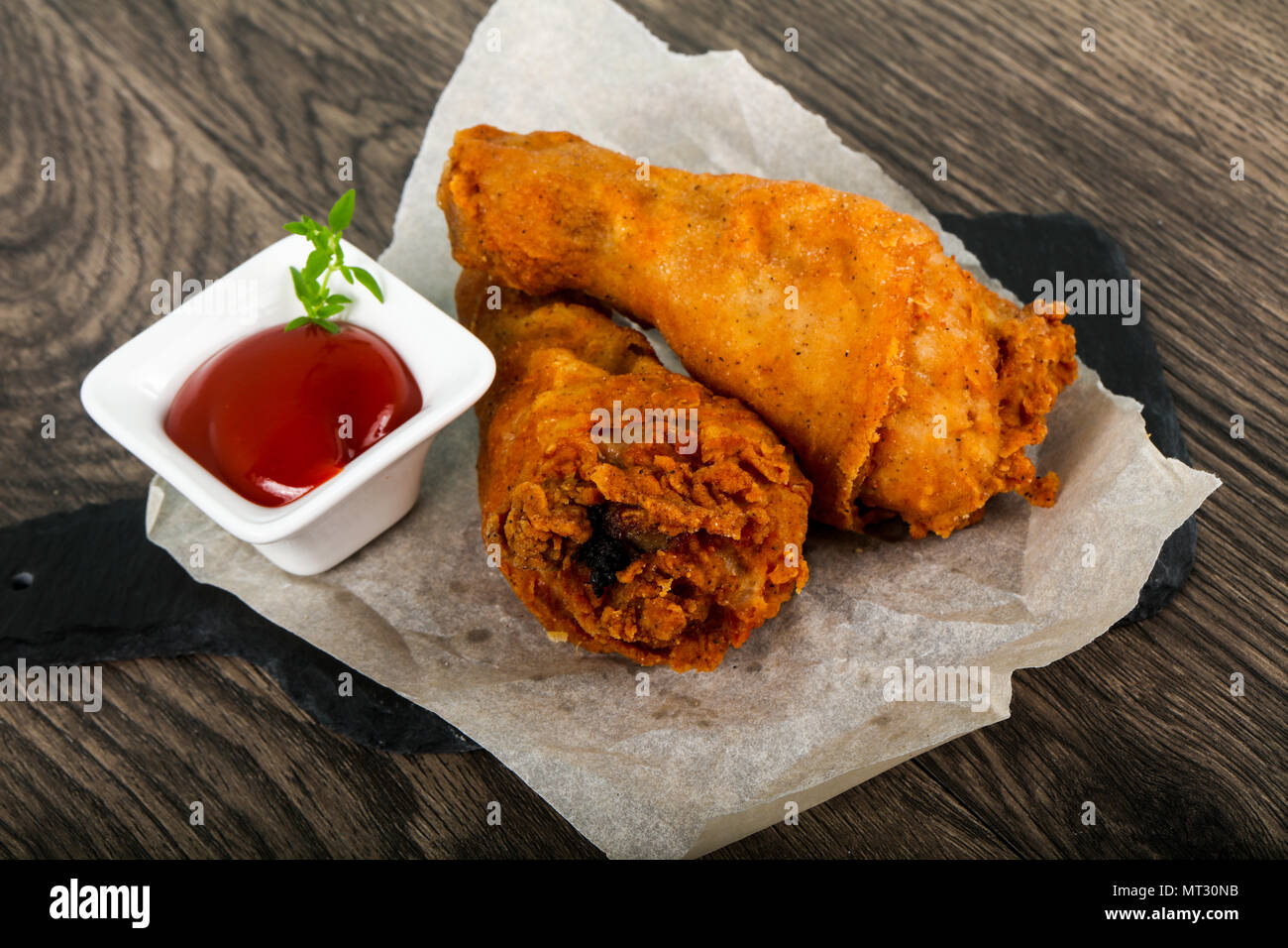 Crispy chicken legs with ketchup Stock Photo - Alamy