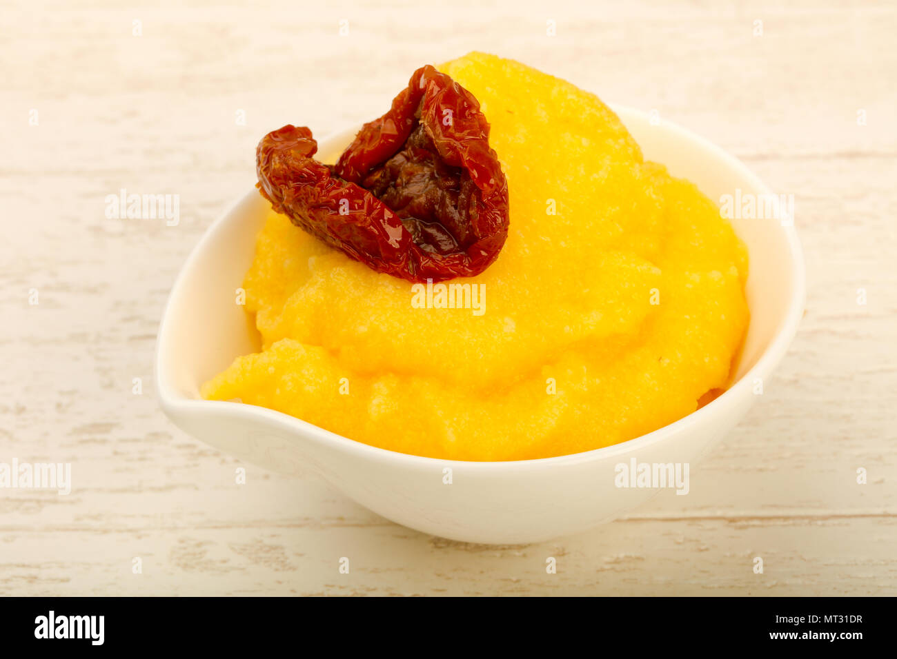 Polenta with dry tomato Stock Photo - Alamy