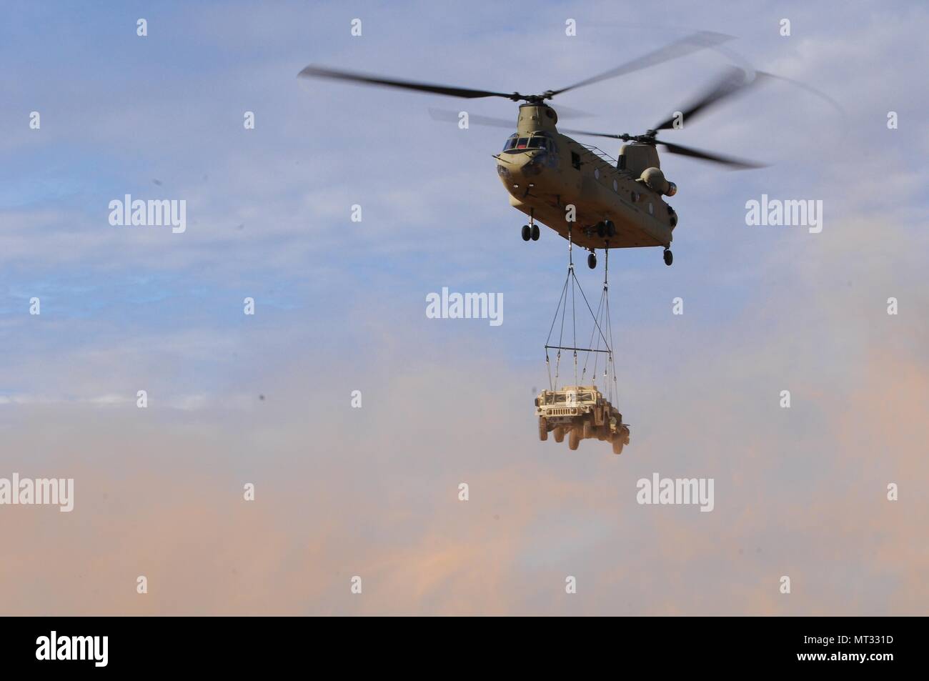 CH-47 Chinook transports a HUMVEE during a sling load operation as part of the Network ...