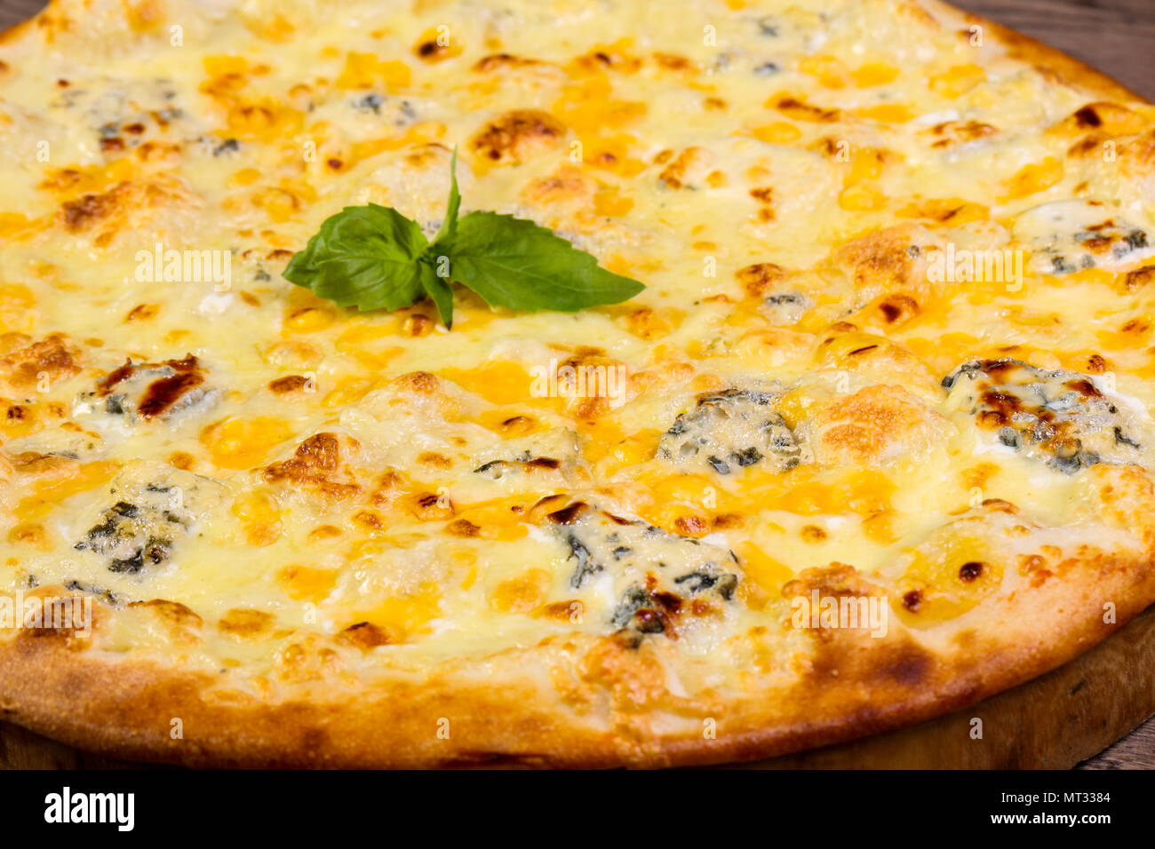 Four cheese pizza served basil Stock Photo - Alamy