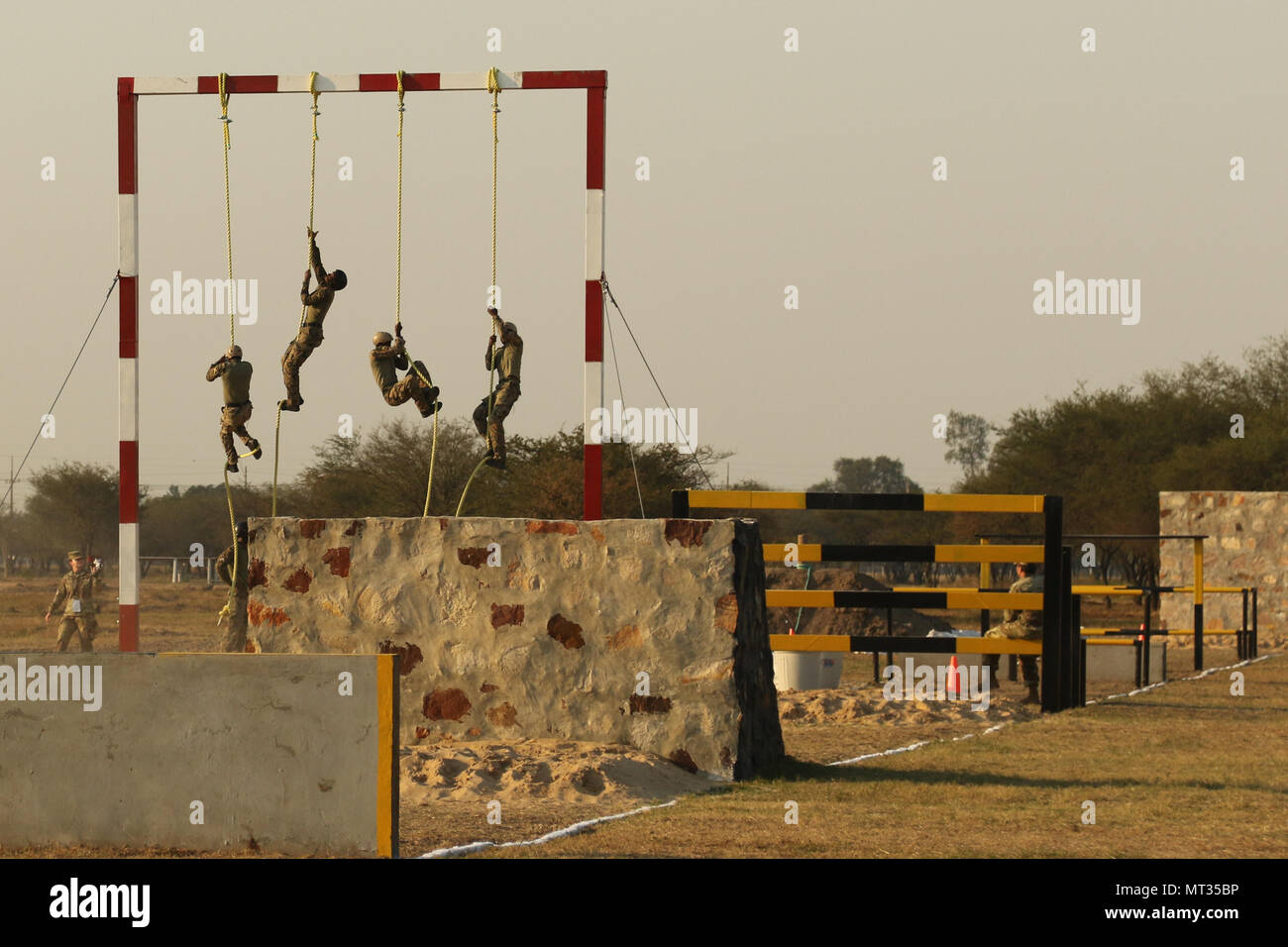 Jamaican competitors ascend ropes during an obstacle course for Fuerzas ...