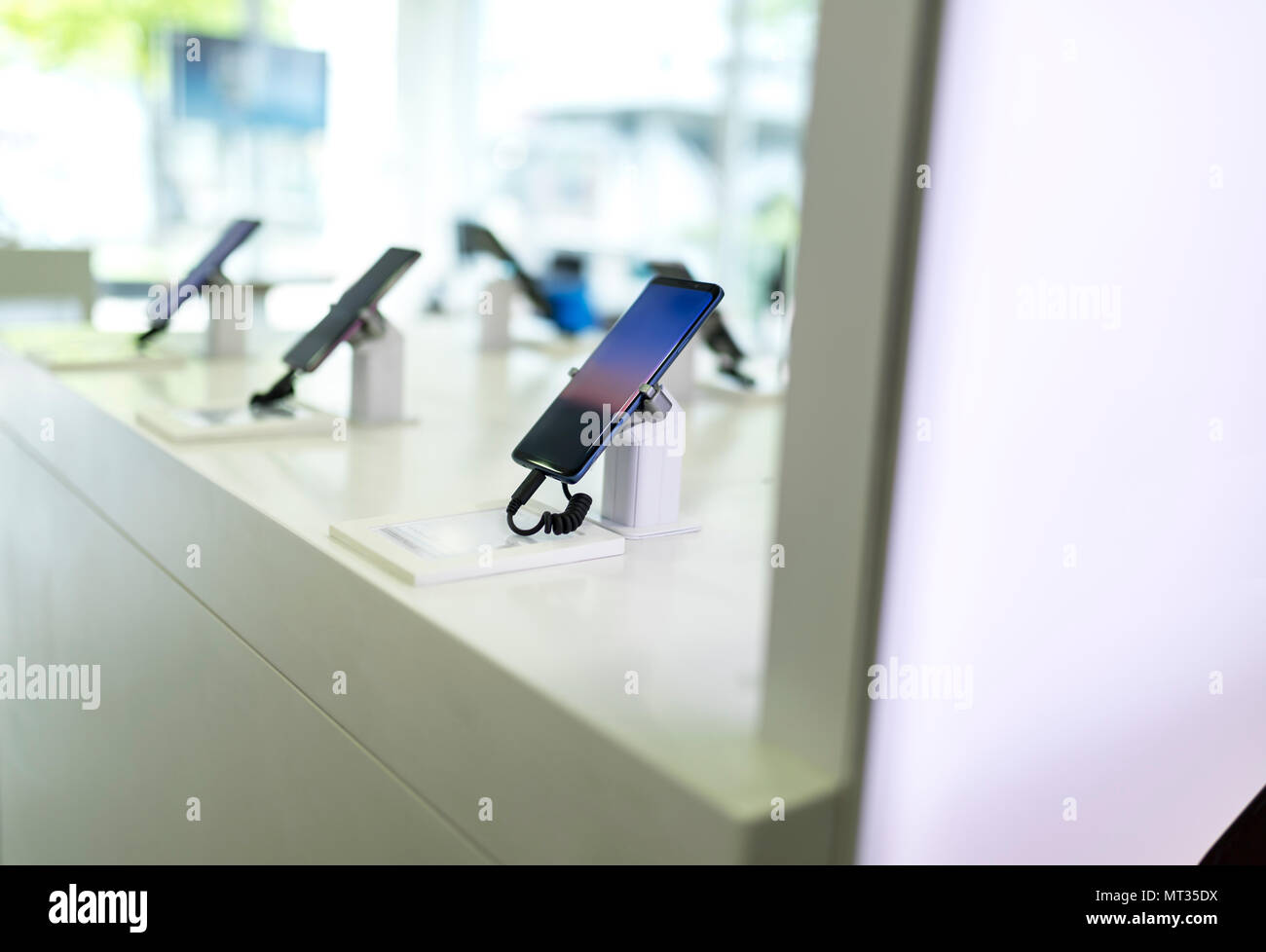 Close up of cell phones or mobile phones on display in a modern, clean ...