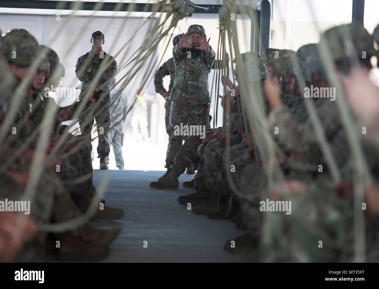 U.S. Soldiers of the 82nd Airborne Division prepare for a jump by ...