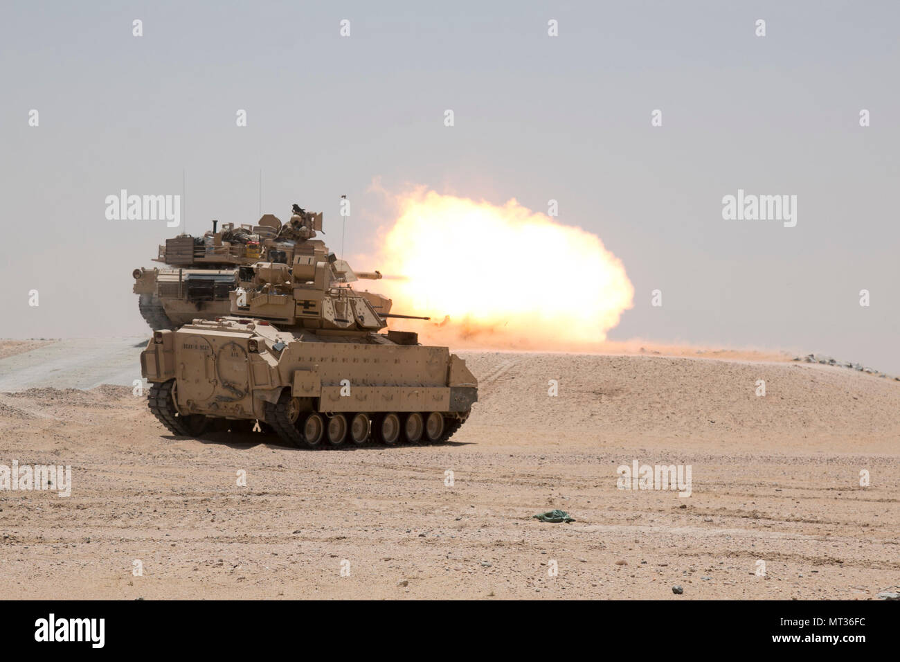 An M1A2 Abrams Main Battle Tank crew engages targets while providing ...