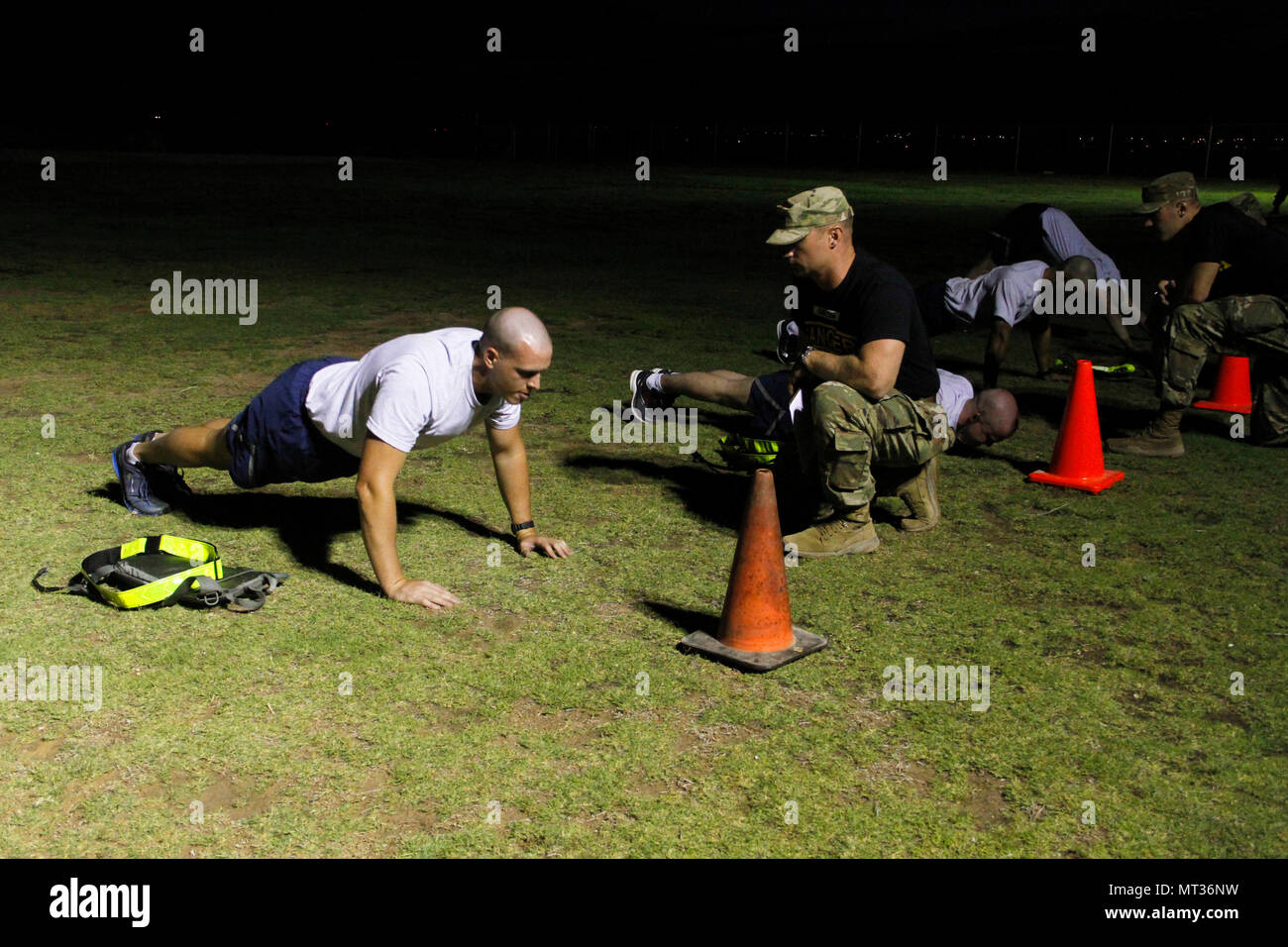 Tech. Sgt. Tom Cook, right, grades an Airman on his pushups during the ...