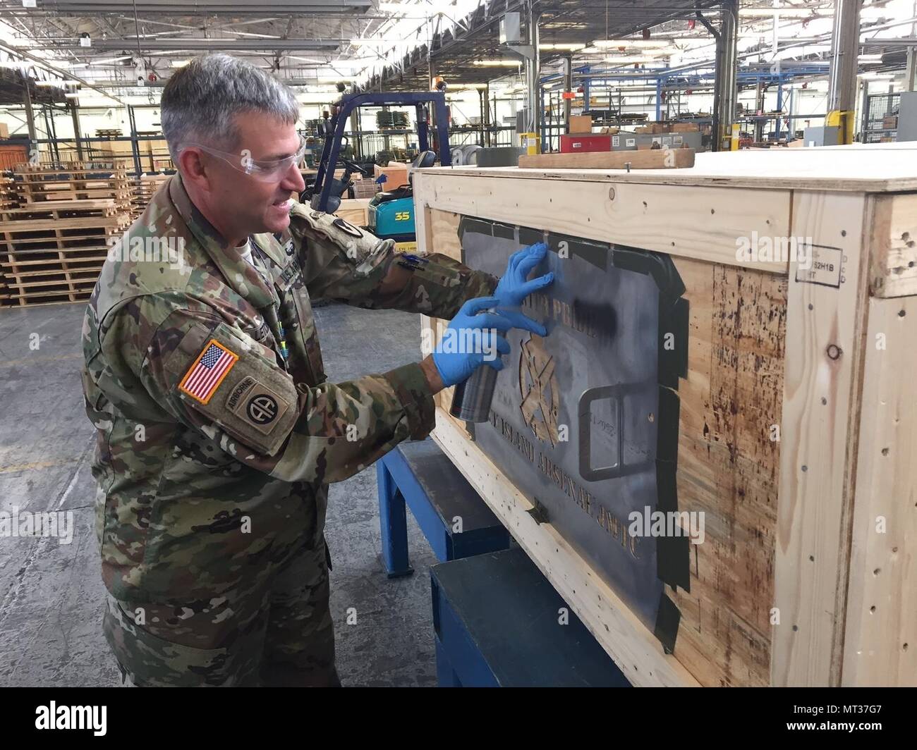 Col. Kenneth W. Letcher, RIA-JMTC commander sprays the first stencil ...