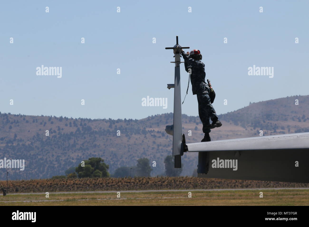 A Sailor from Naval Air Station Lemoore, helps secure an F/A-18 Super ...