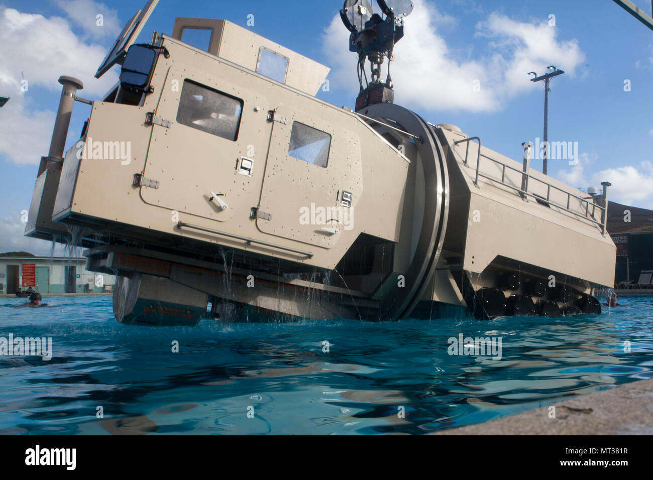 A Submerged Vehicle Egress Trainer (SVET) submerges into water during ...