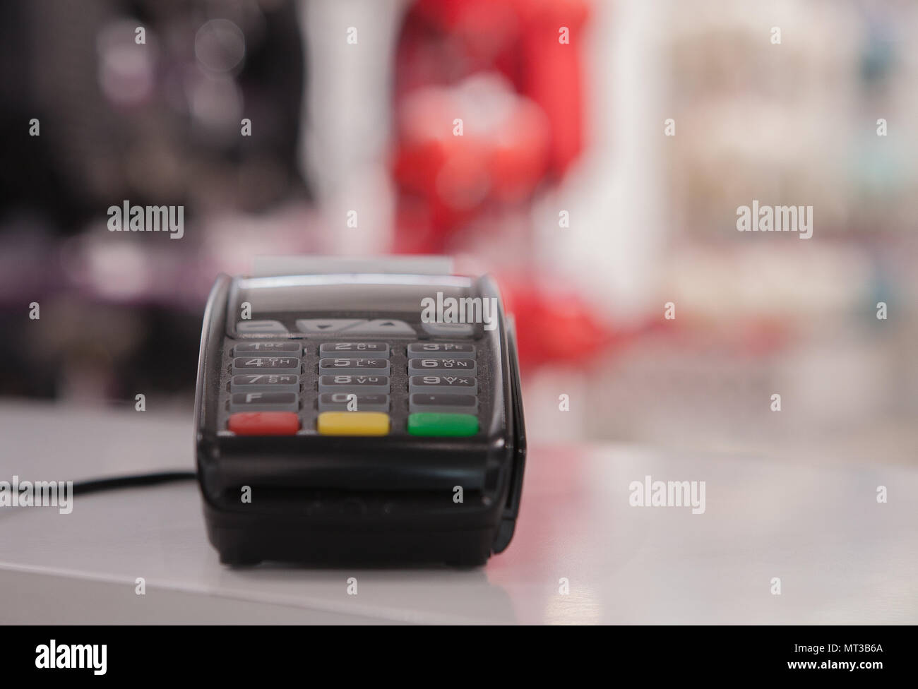 POS payment terminal on white table in shop Stock Photo - Alamy