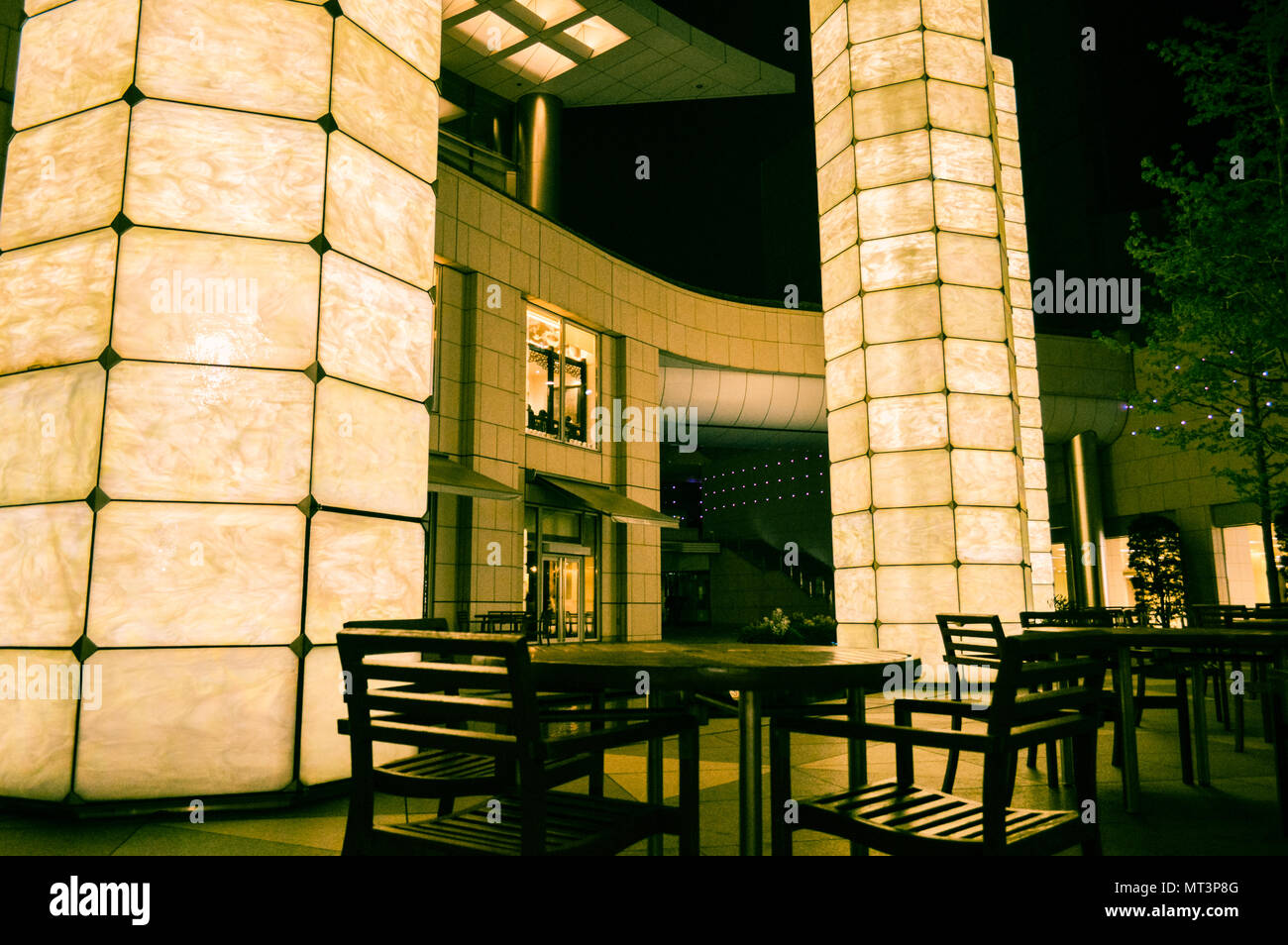 Night view of public installation of glowing lantern towers behind ...