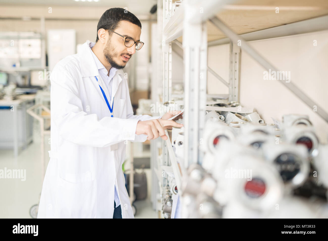 Concentrated test engineer examining pressure sensors Stock Photo - Alamy