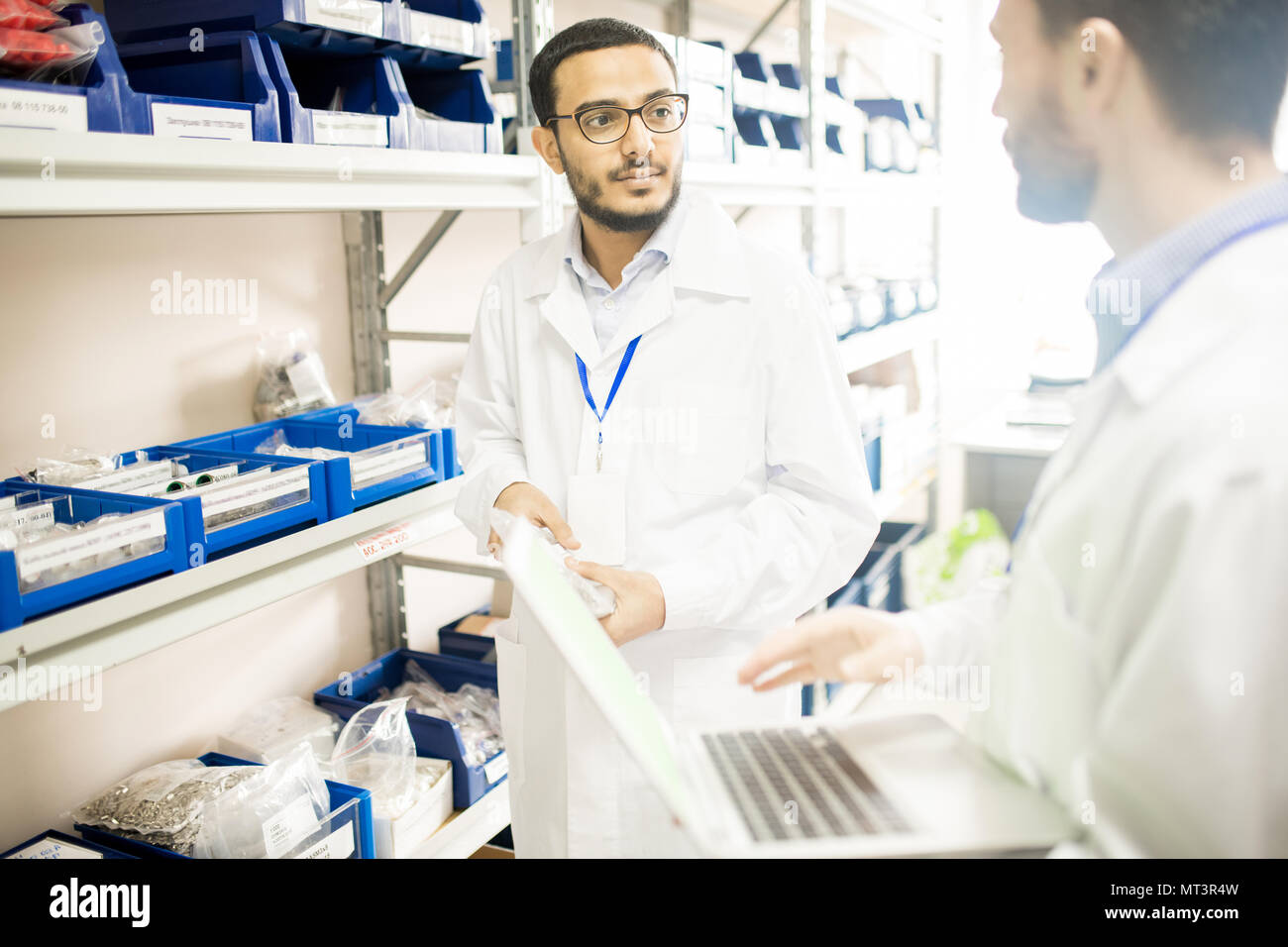Smart engineers discussing new devices in warehouse Stock Photo - Alamy