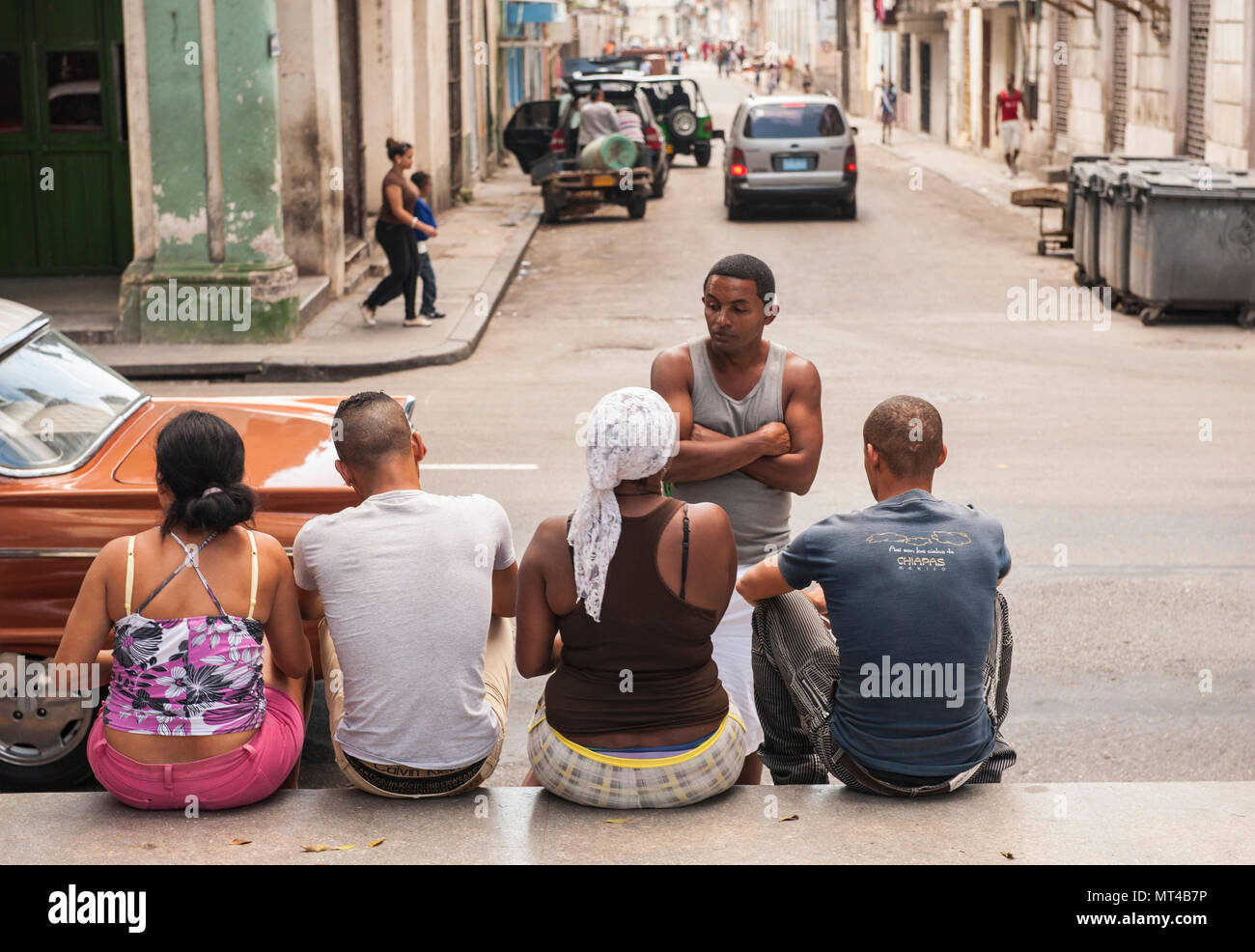Local Cubans hanging out in Central Havana talking together sitting ...