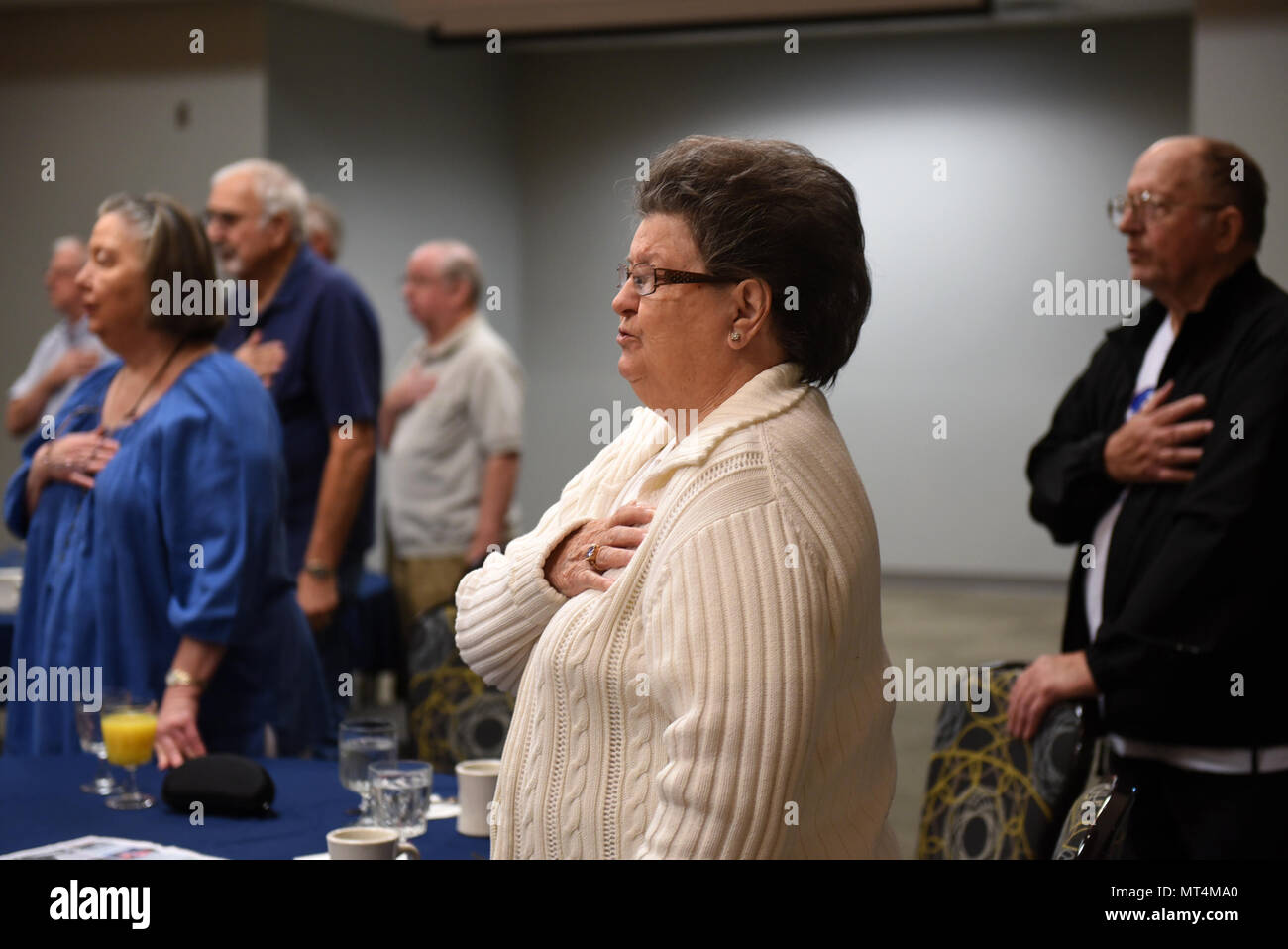 Retired service members and their spouses state the Pledge of ...