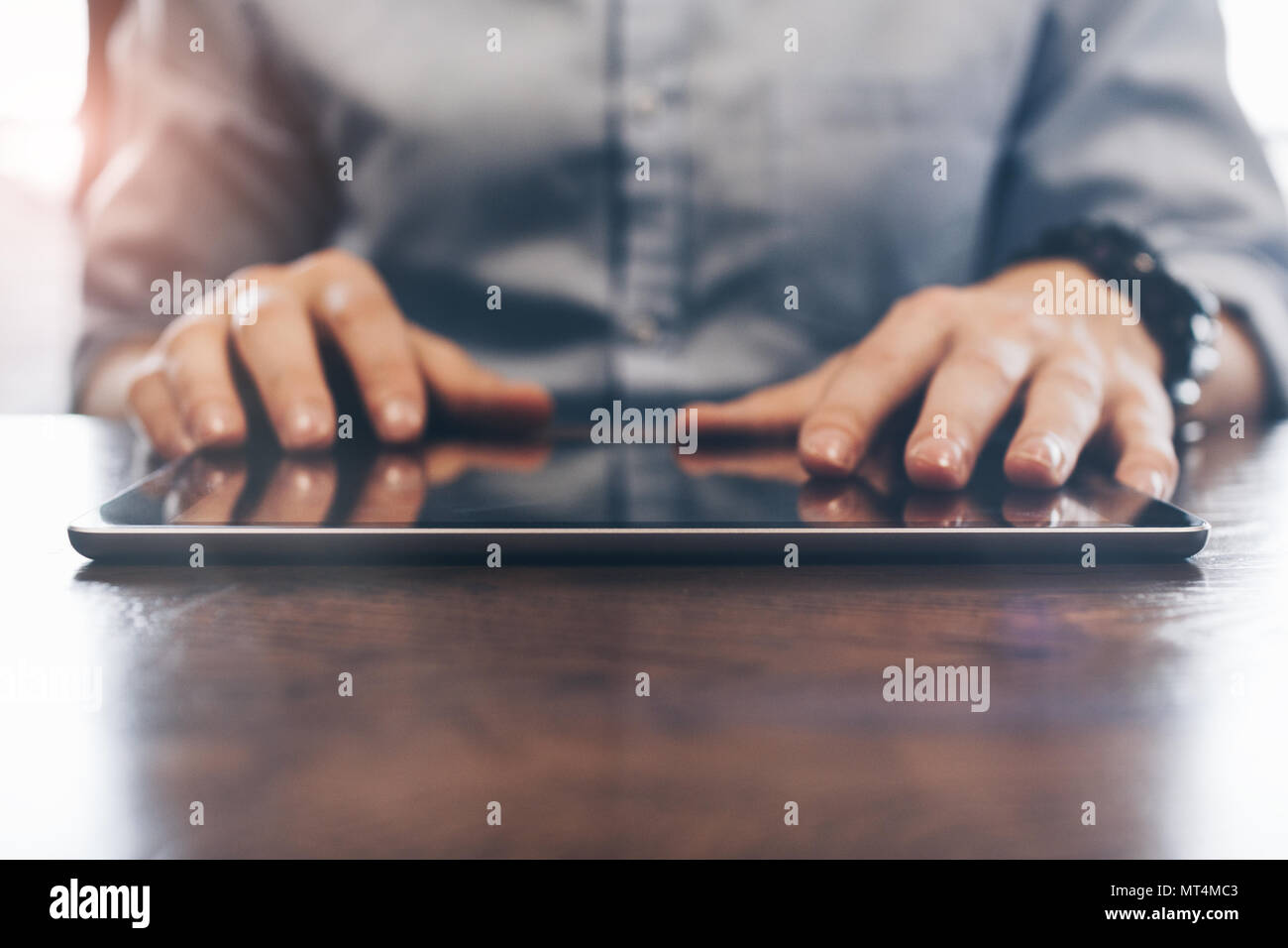 Closeup photo male hands touching screen tablet. Concept of using ...