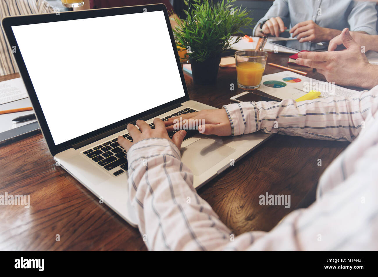 Coworkers working. Young woman working together with colleagues and ...