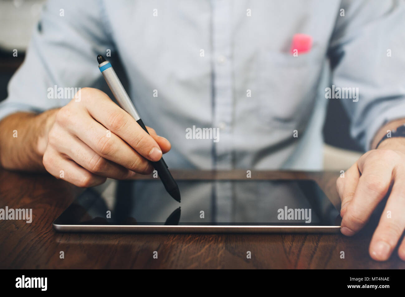 Close up view of a man's hands and digital tablet. Businessman holds a ...