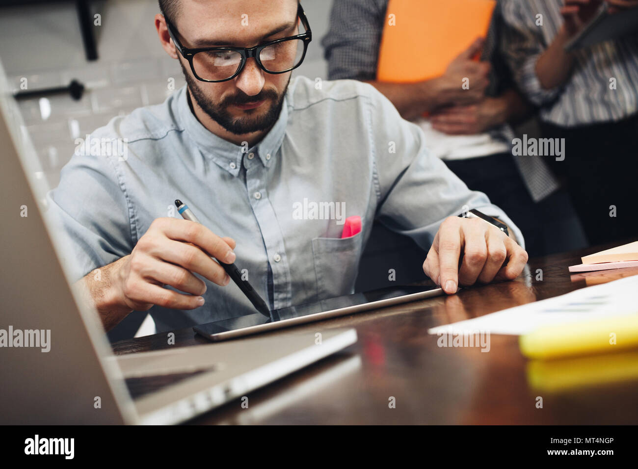 Bearded young trader analyzes and studies investment market. Man is ...