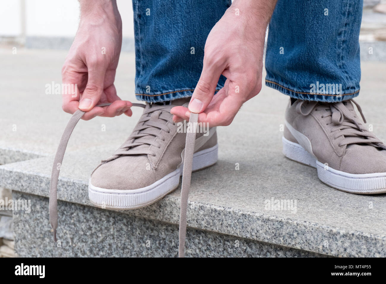 Men's hands tying laces ready for walking Stock Photo - Alamy