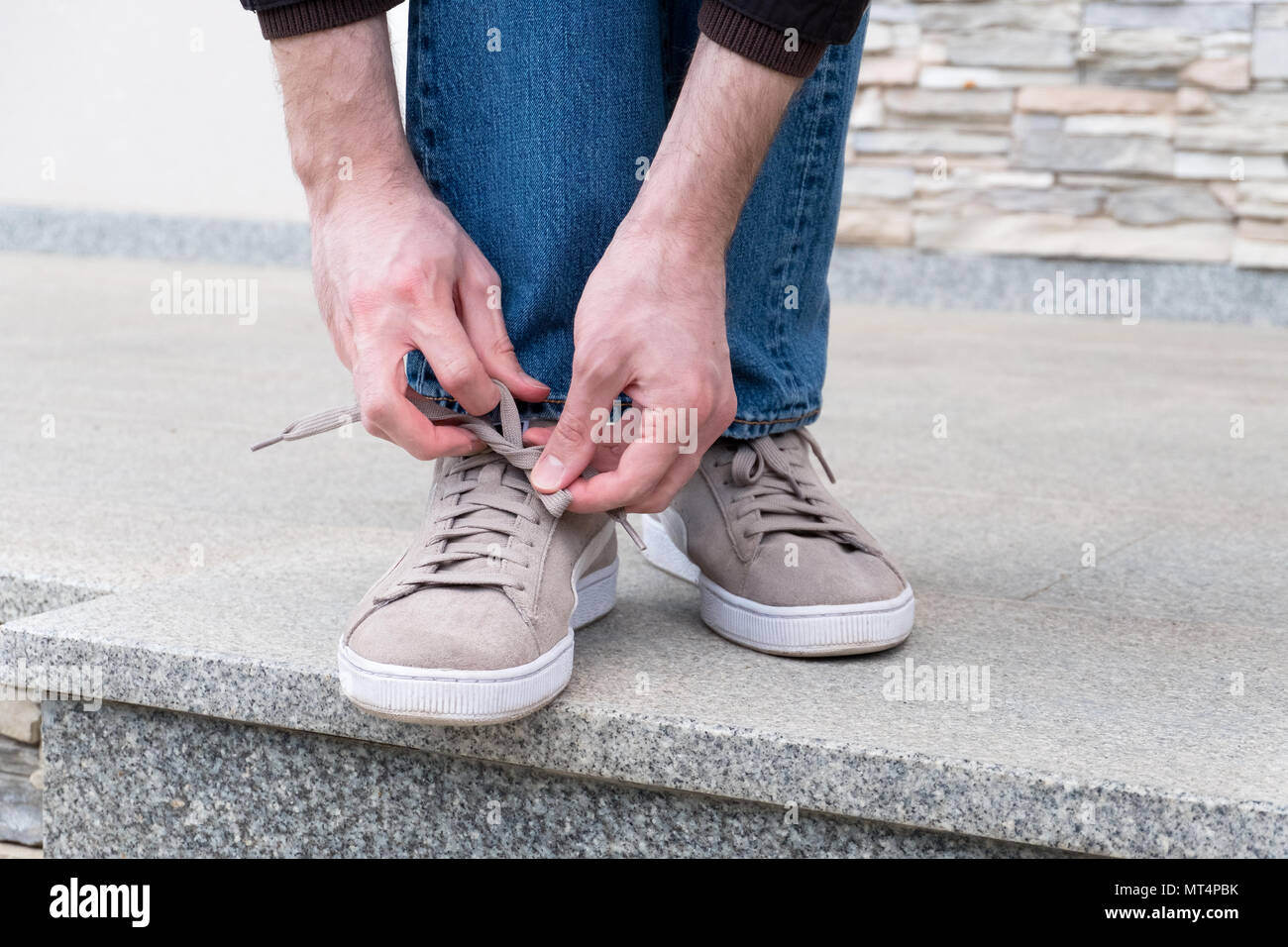 Men's hands tying laces ready for walking Stock Photo - Alamy