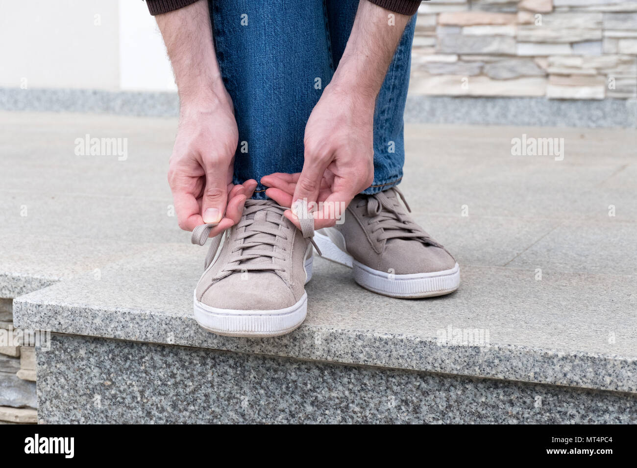 Men's hands tying laces ready for walking Stock Photo - Alamy