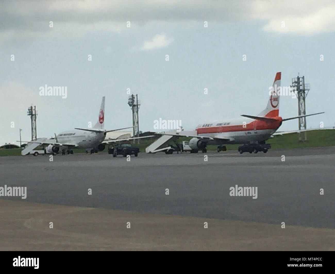 U.S. Airmen service two Japan Airlines Boeing 737 passenger aircraft ...