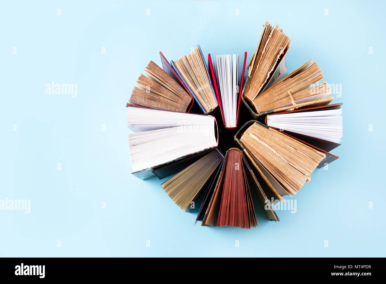 Pile of old books on blue background with copy space Stock Photo - Alamy
