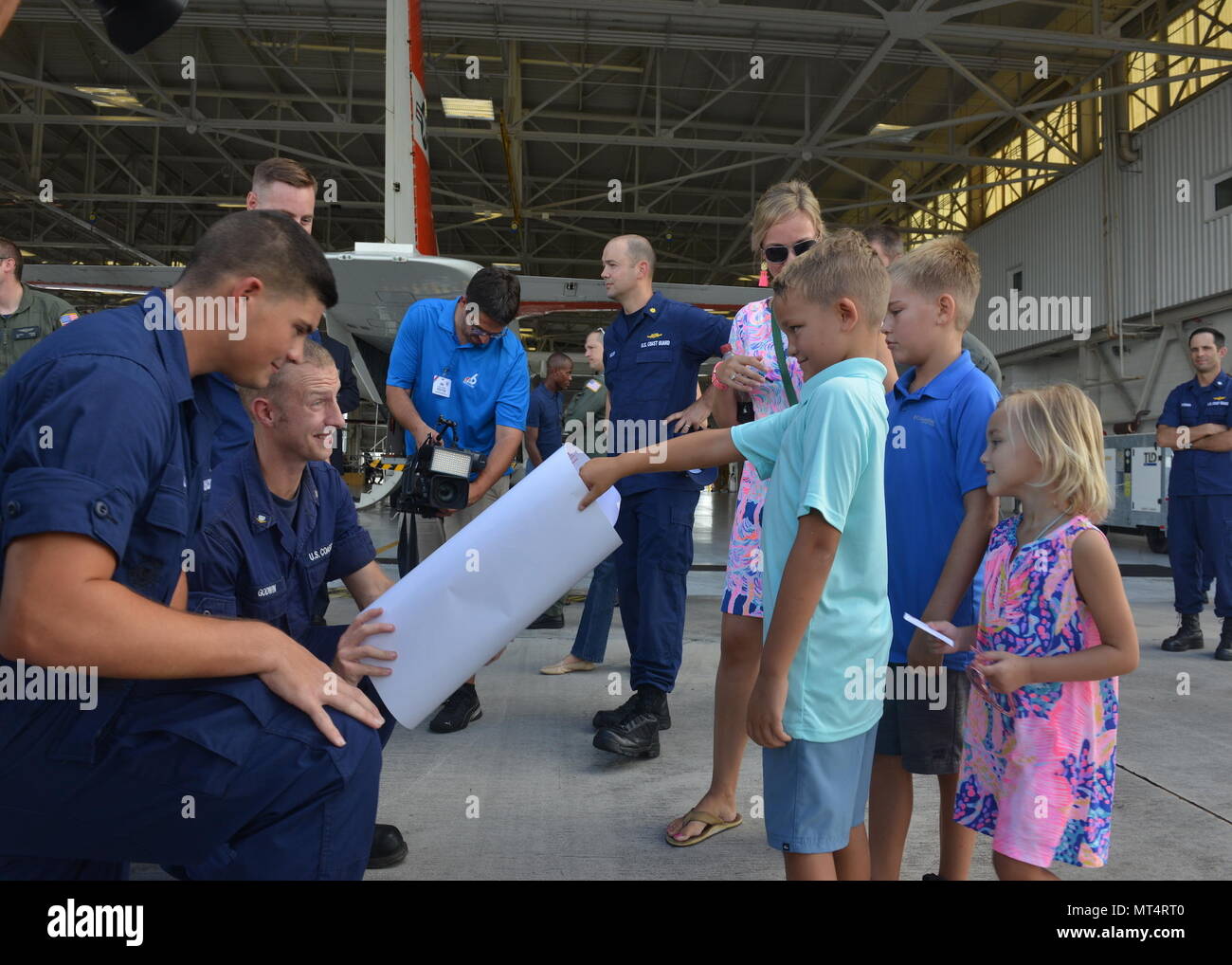 The Varell children present a sign they made for the Coast Guard ...