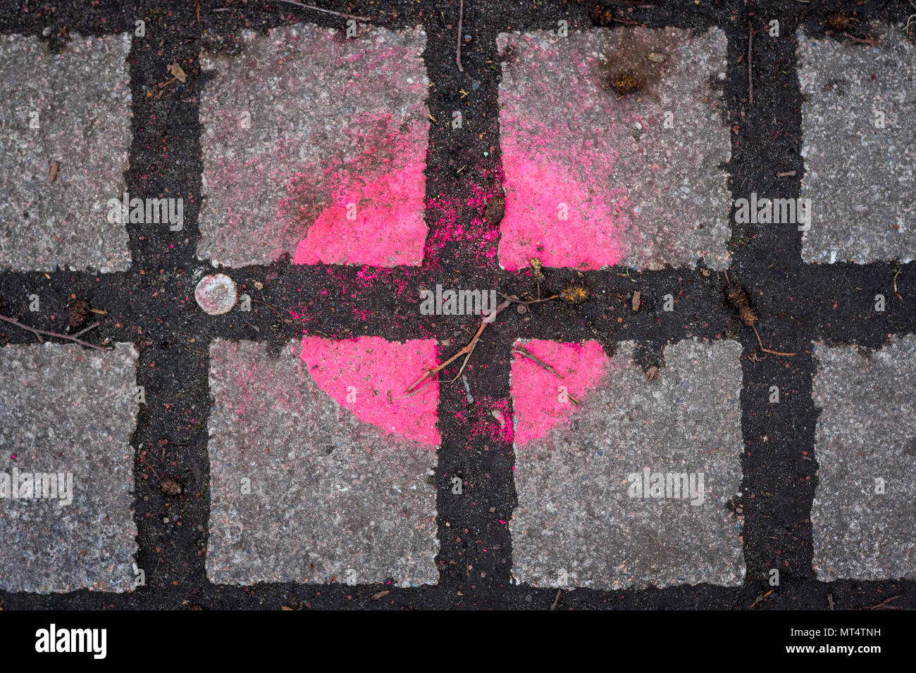 A pink dot sprayed onto a pavement in Berlin, Germany Stock Photo - Alamy