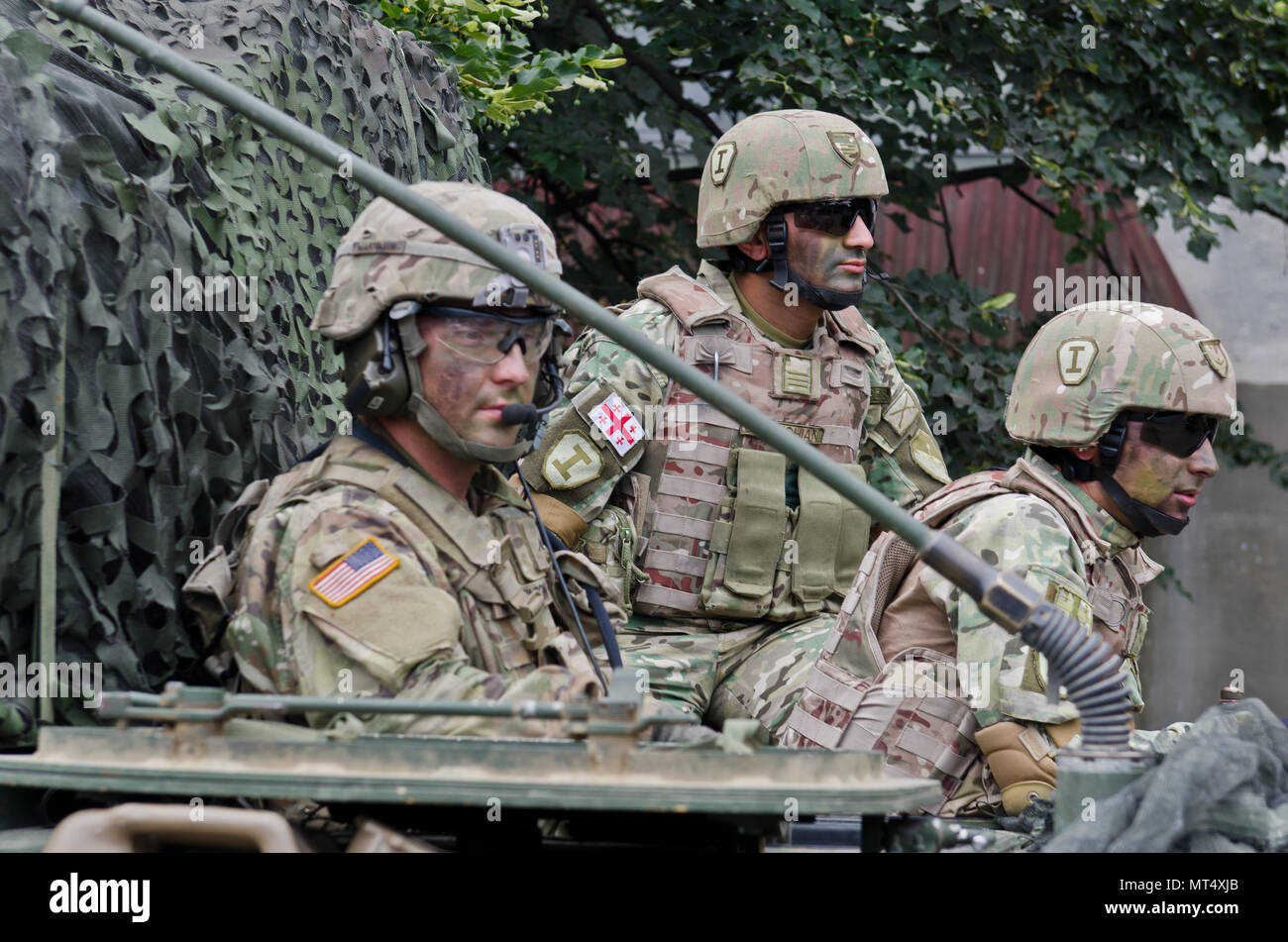 U.S. and Georgian Soldiers position themselves in the rear airguard ...
