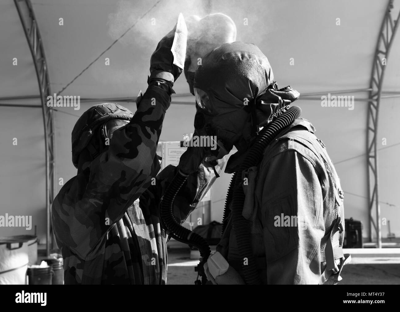 An aircrew flight equipment Airman uses M295 mitts to simulate removing ...