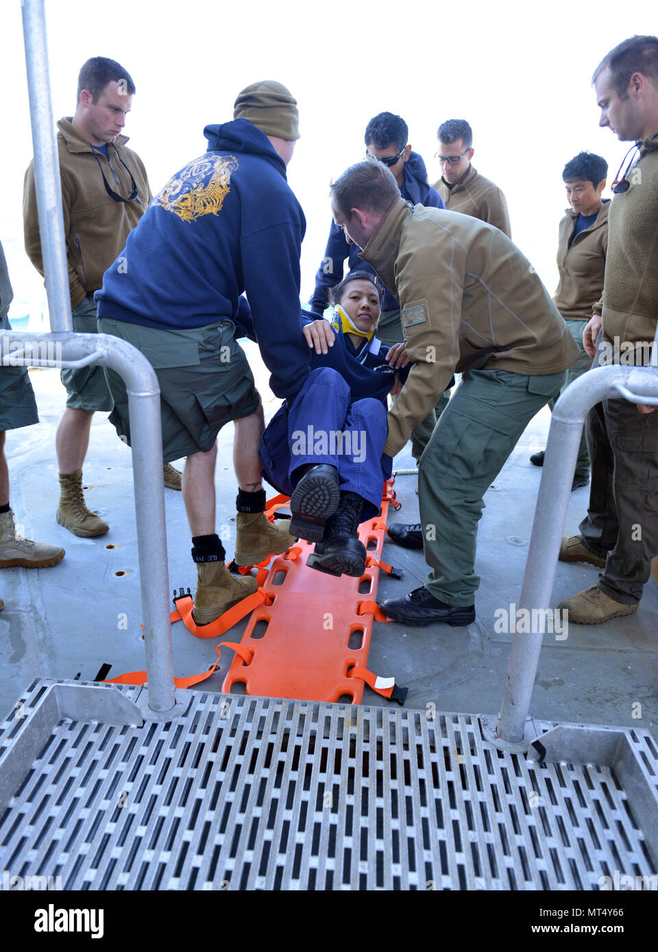 Petty Officer 1st Class Kim Nguyen (center) participates in a joint U.S ...