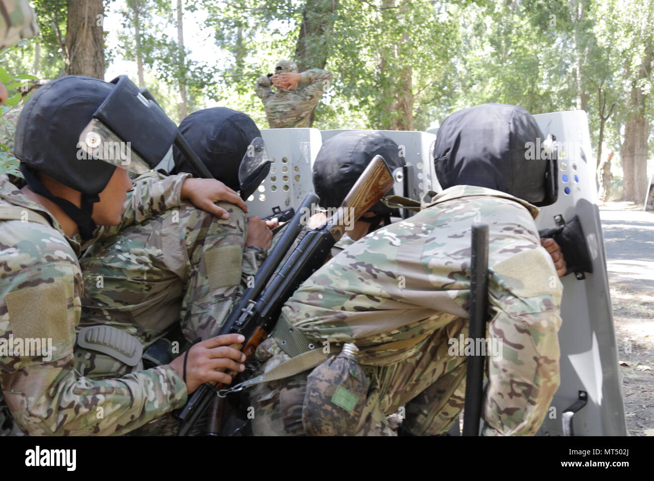 A Kazakhstani platoon leader gives a class and practices movements with ...