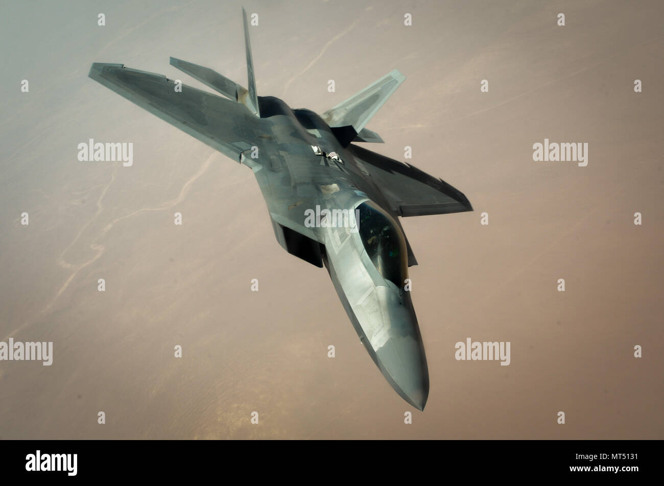 A U.S. Air Force F-22 Raptor departs after in-flight refueling from a ...