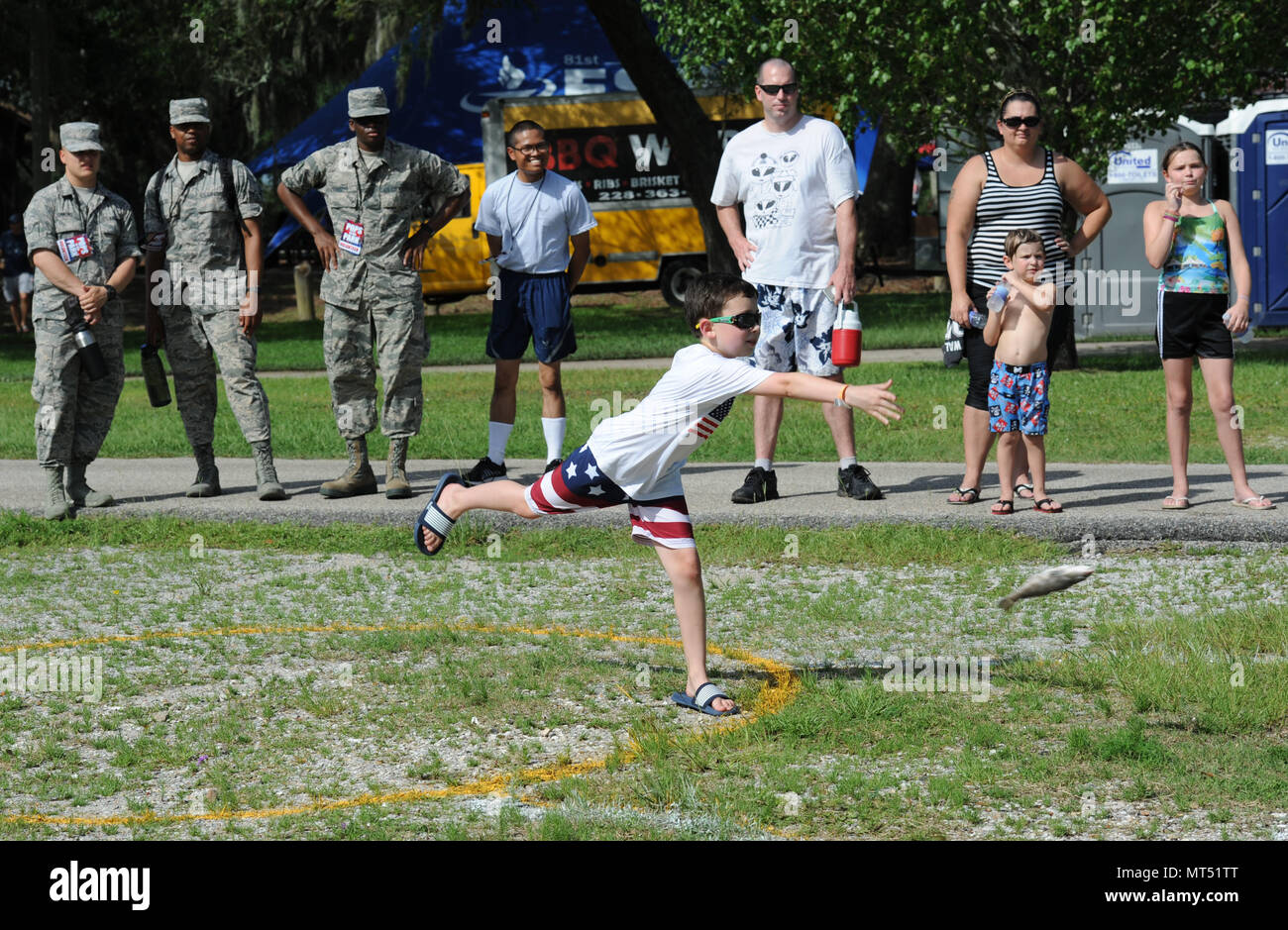 Conner Cliett, son of retired U.S. Marine Corps William Byrd, tosses a ...