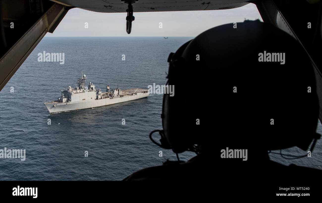 A flight engineer with the 8th Special Operations Squadron looks on as ...