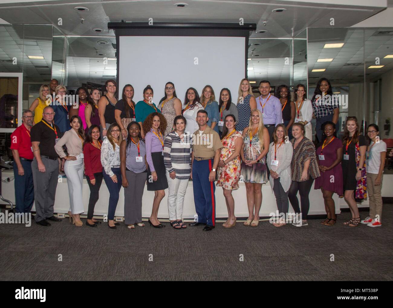 U.S. Marines and spouses with 6th Marine Corps District (6MCD) pose for ...
