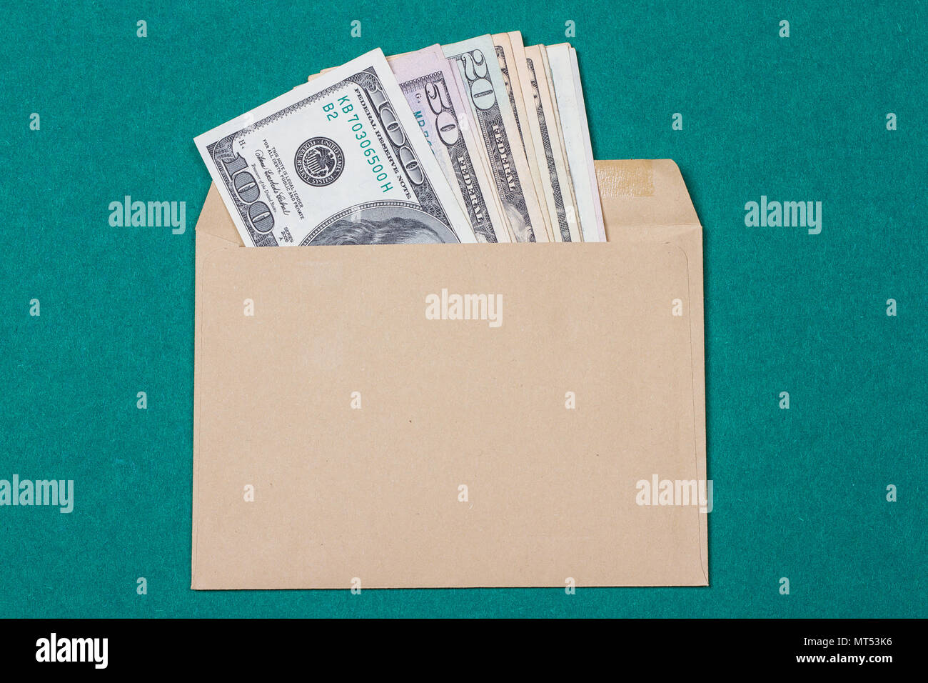 cash in an envelope on a green background Stock Photo - Alamy